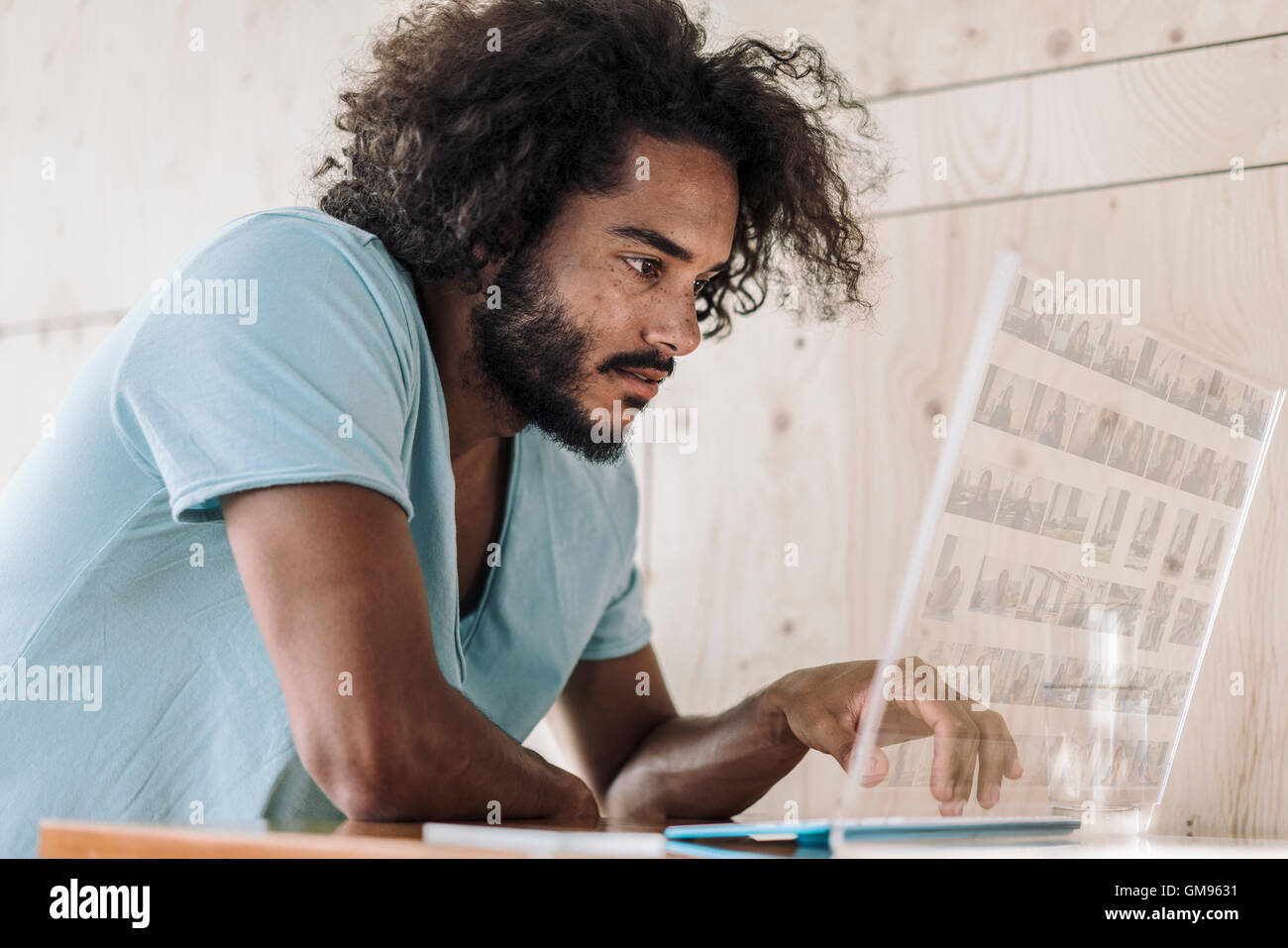 Young man using futuristic computer Stock Photo - Alamy