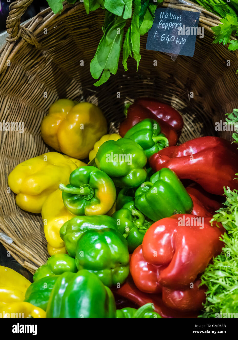 Green, red and yellow peppers in basket on sale at a Borough farmers ...