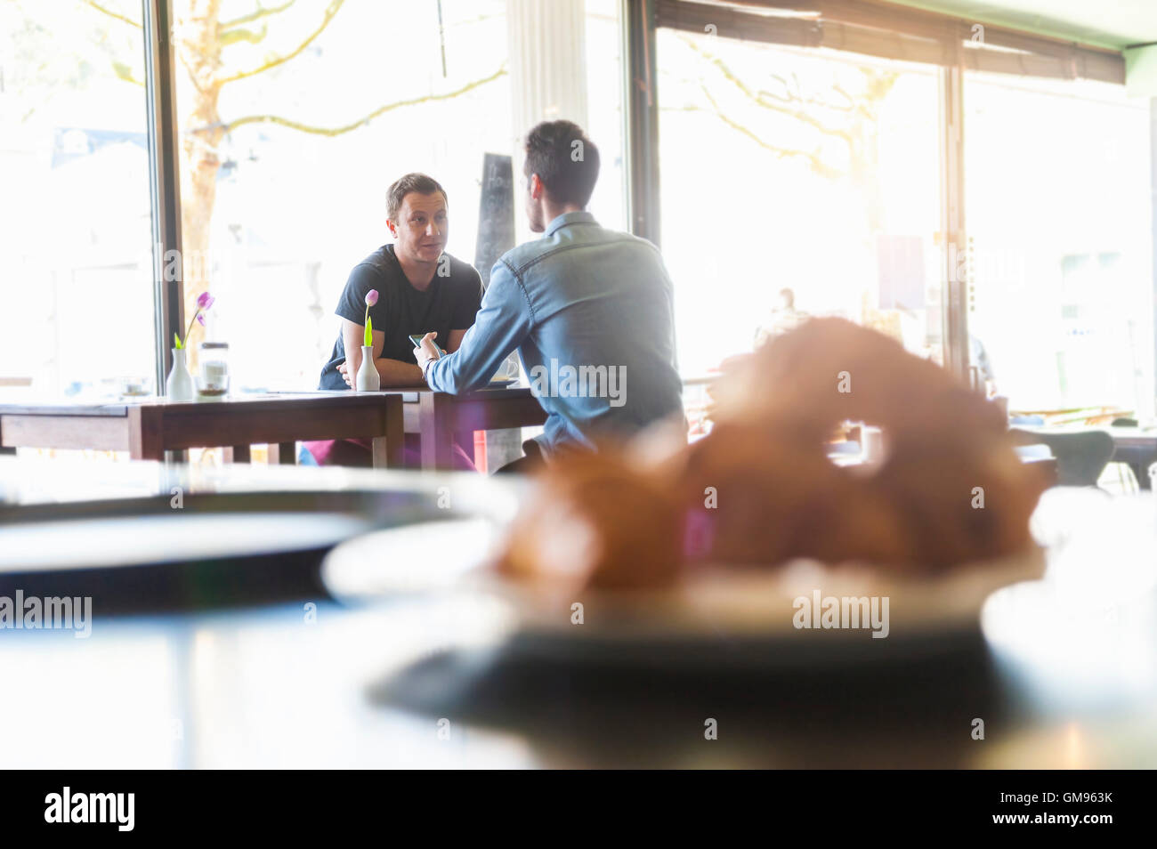 Two young men socializing in a cafe hi-res stock photography and images ...
