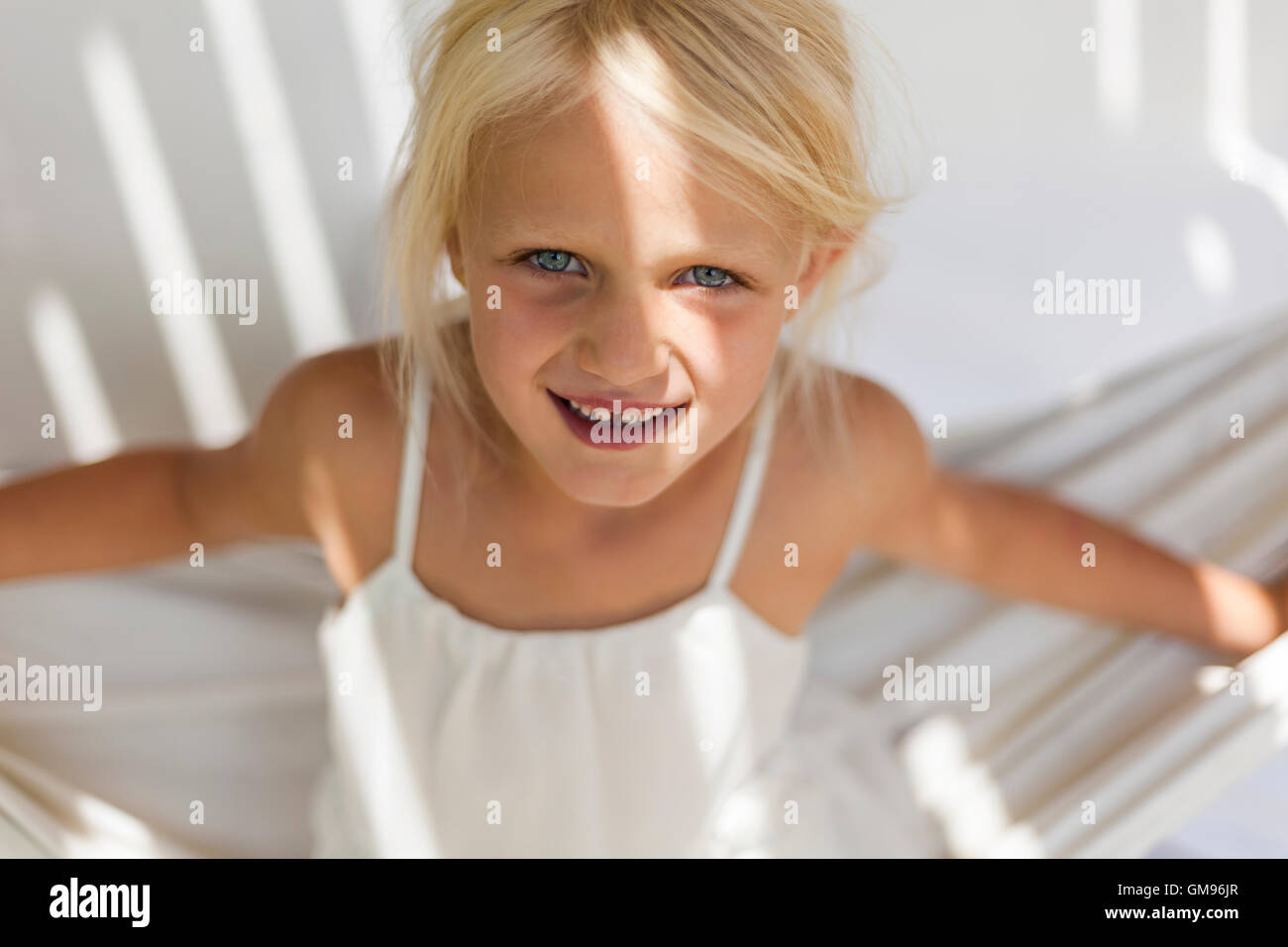 Portrait of smiling little girl with tooth gap in a hammock Stock Photo ...