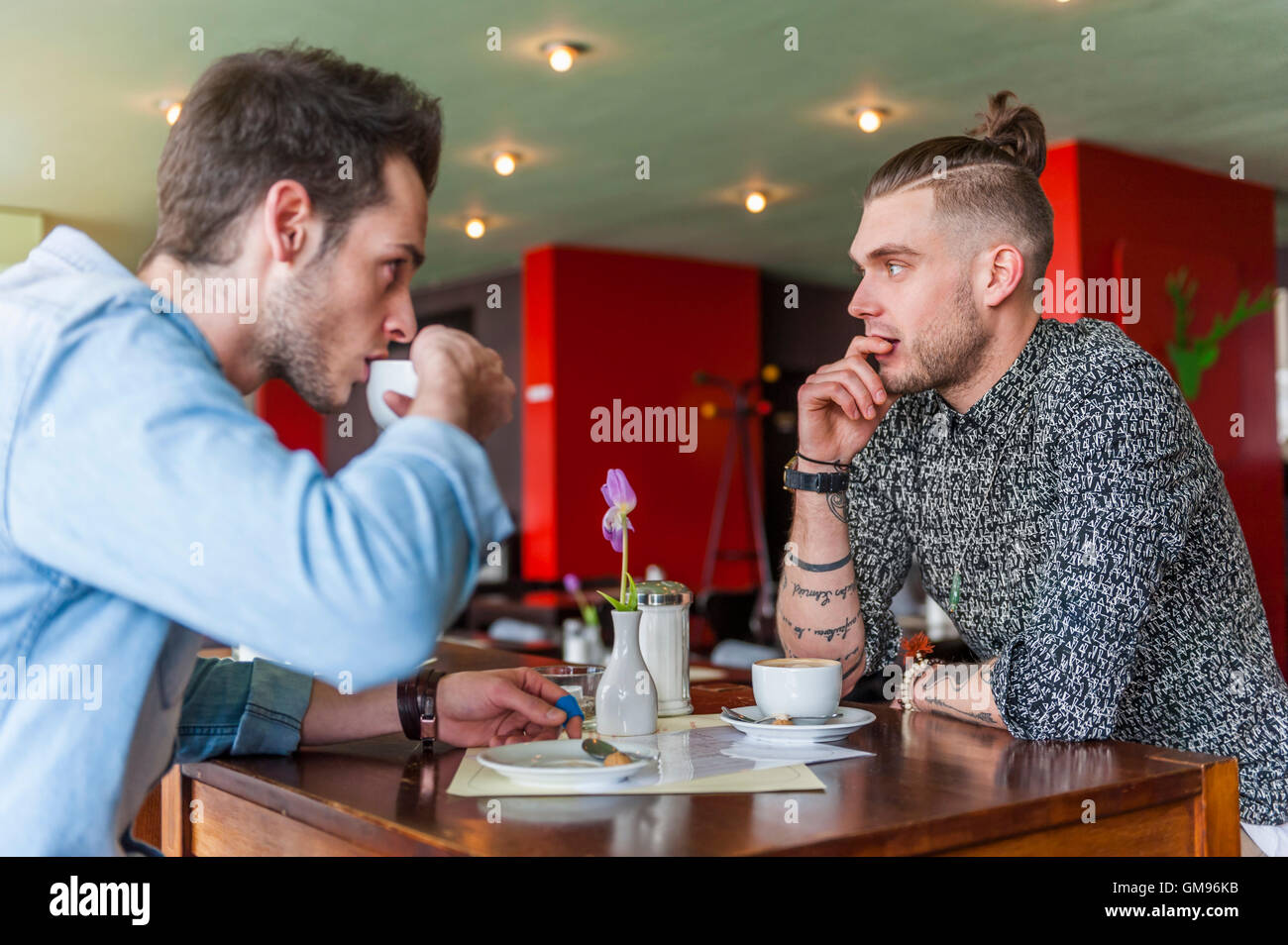 To men drinking coffee in a cafe Stock Photo - Alamy