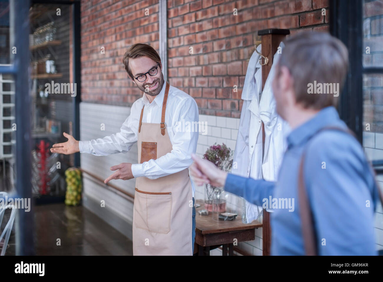 Welcoming customer hi-res stock photography and images - Alamy