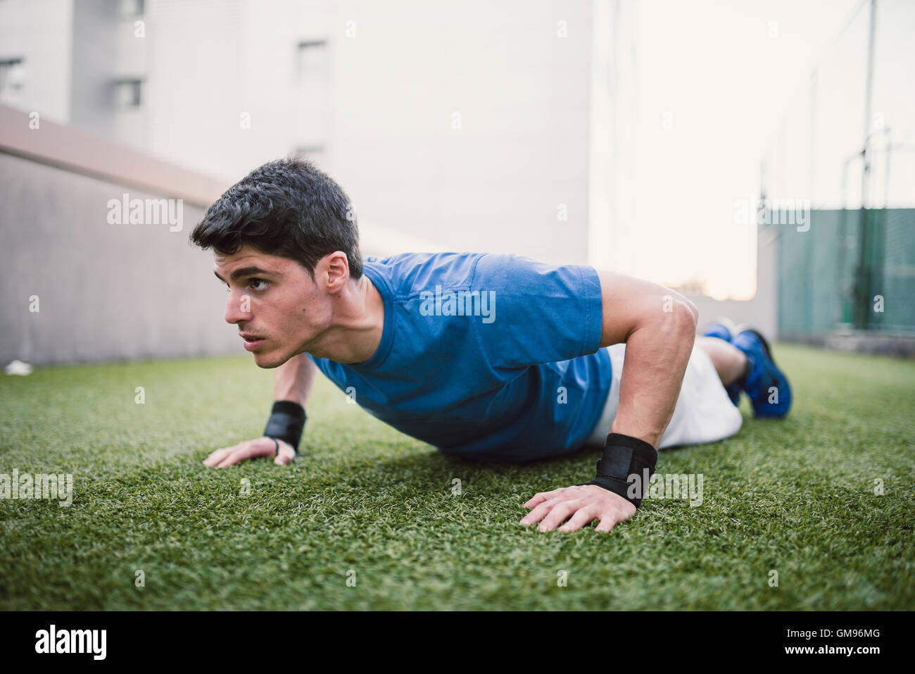 Athlete man doing pushups outdoor Stock Photo - Alamy