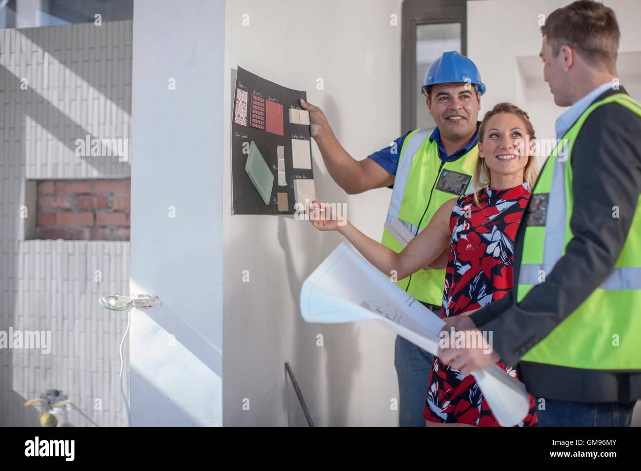 Architect, construction worker and smiling woman Stock Photo - Alamy