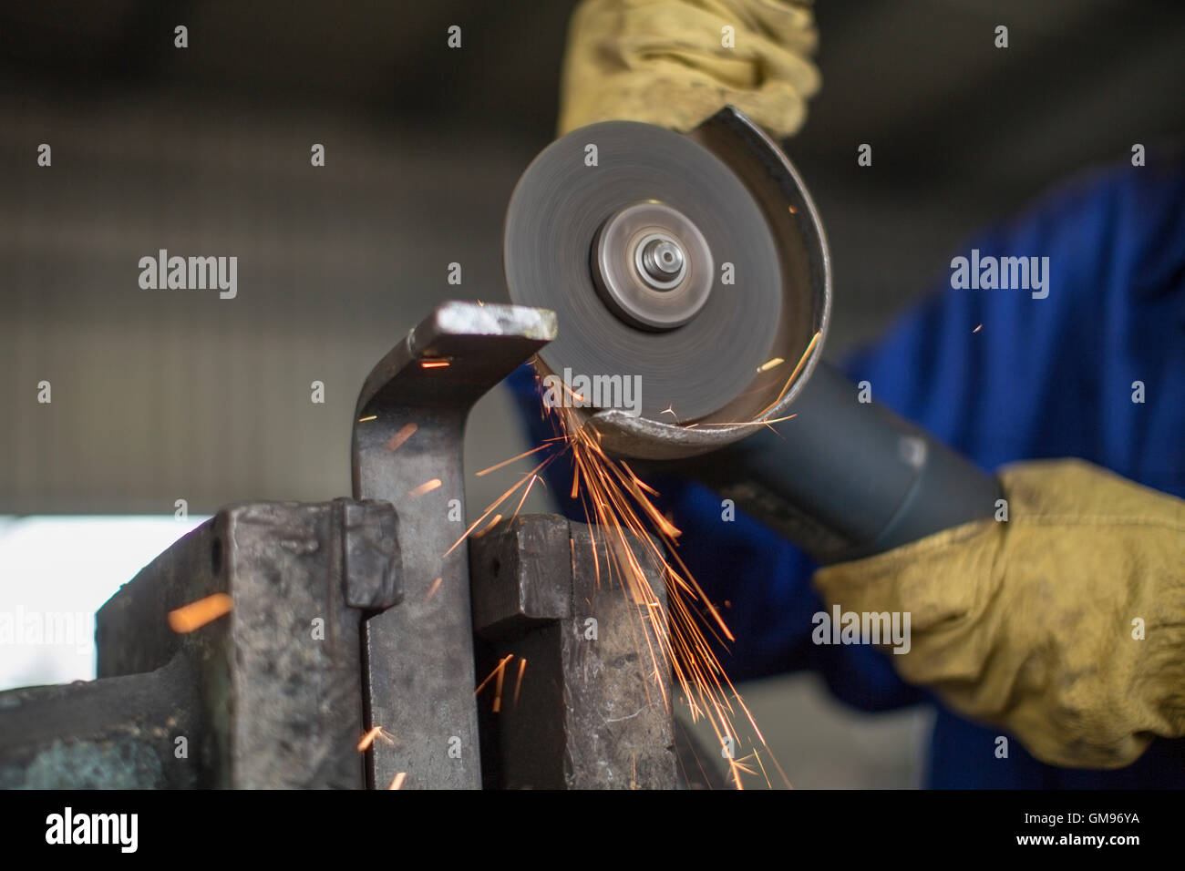 Mechanic using grinding machine in workshop Stock Photo - Alamy