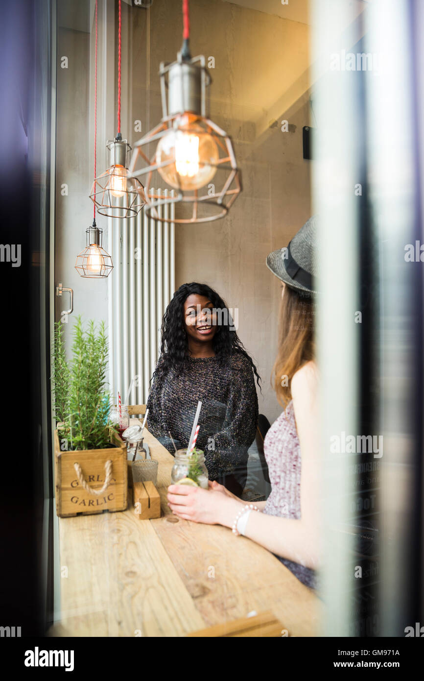 Two friends talking in a cafe Stock Photo - Alamy