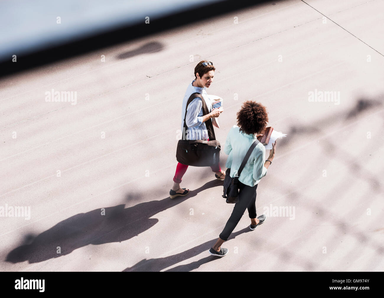 Two people walking together from above hi-res stock photography and ...