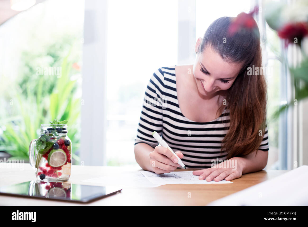 Young woman working on construction plan Stock Photo - Alamy