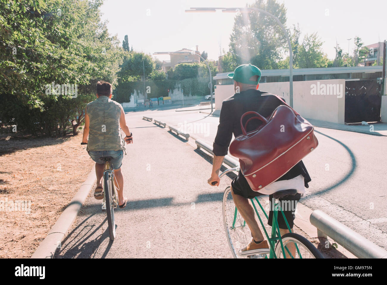 Two men riding bike Stock Photo - Alamy