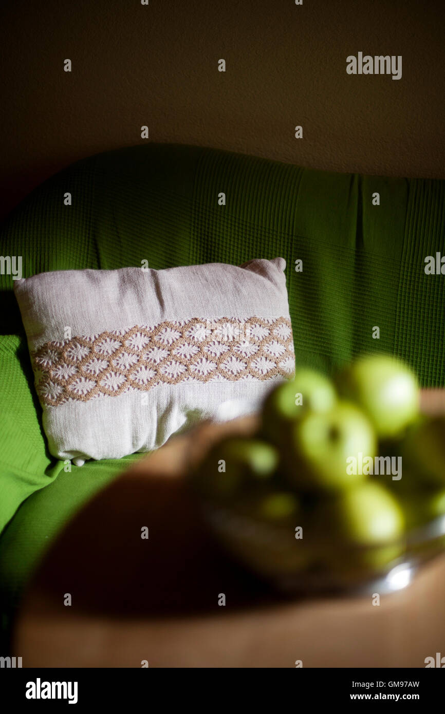 Room with cushion on sofa and fruit bowl Stock Photo - Alamy