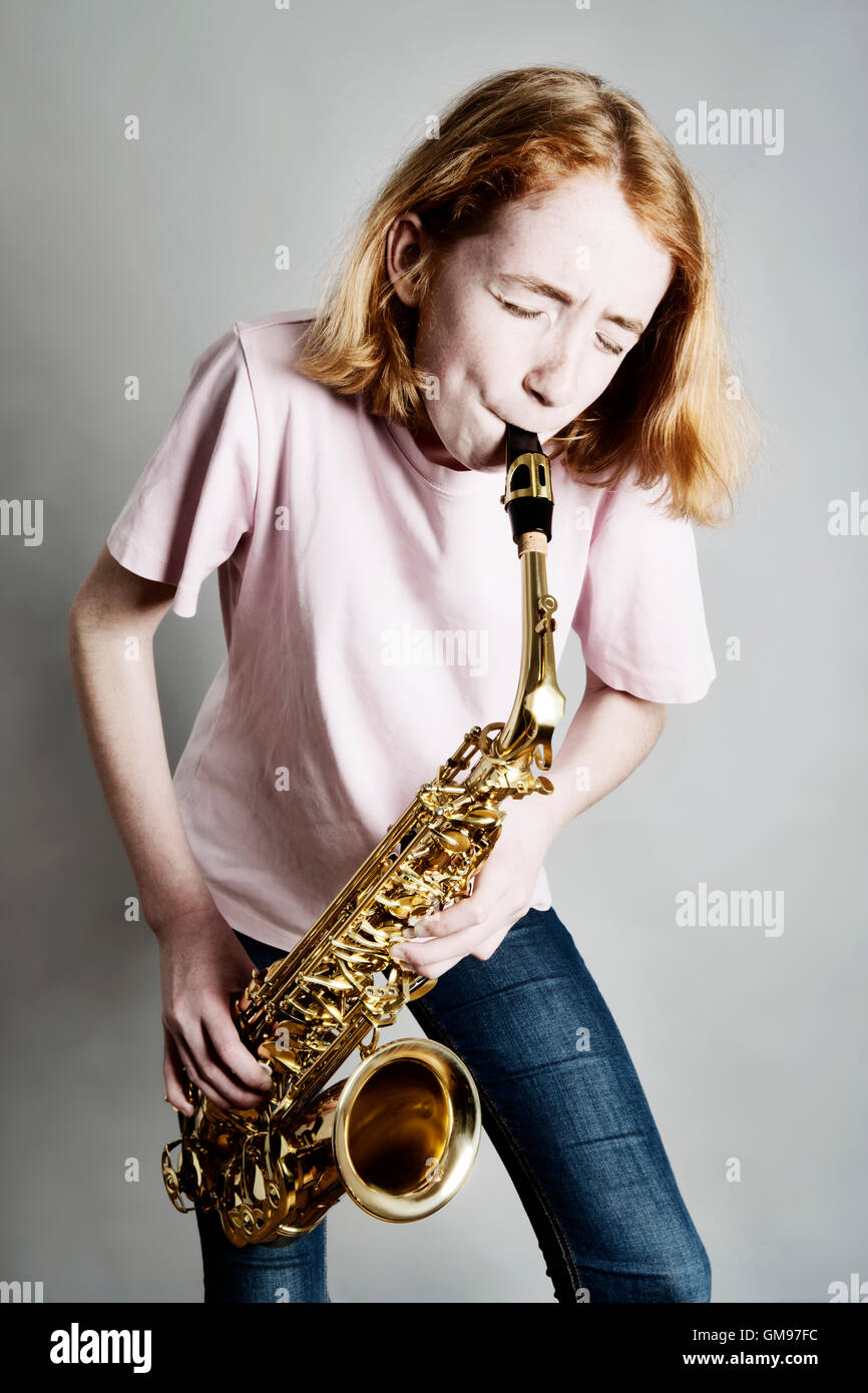 Girl playing saxophone Stock Photo - Alamy