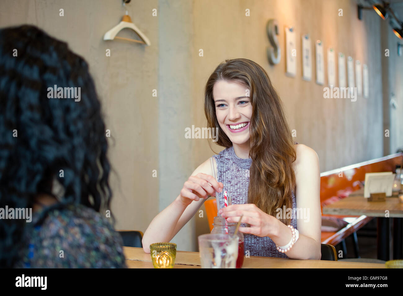 Two friends meeting in cafe, chatting Stock Photo - Alamy