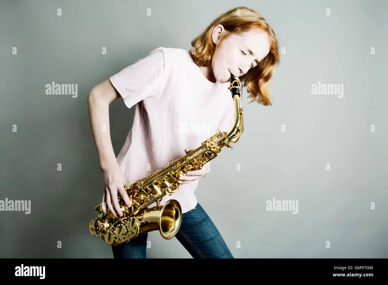 Girl playing saxophone Stock Photo - Alamy