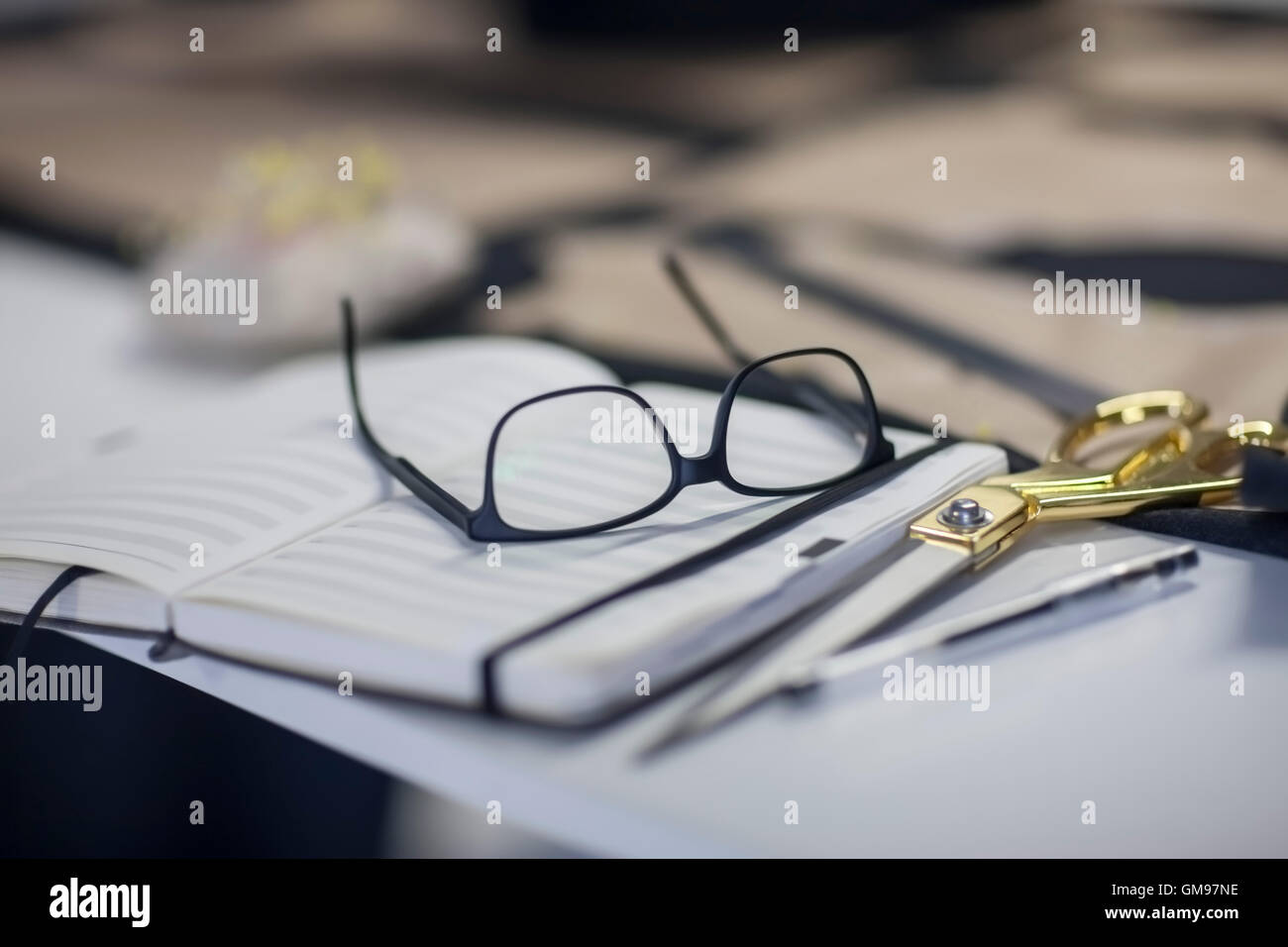 Close-up of scissors, glasses and notebook Stock Photo - Alamy