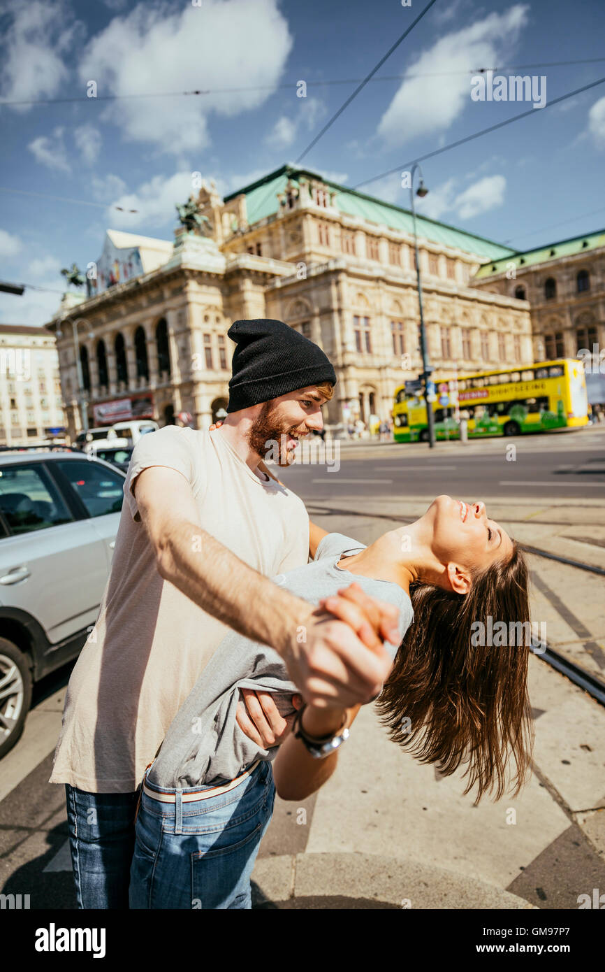 Austria, Vienna, happy young couple dancing Viennese waltz in front of ...