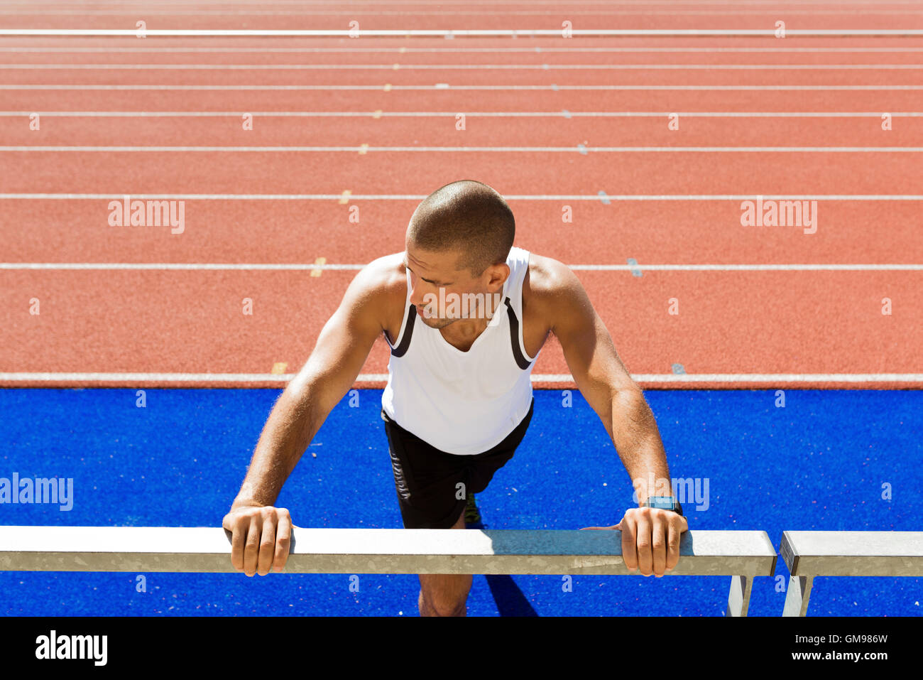 Young sportsman stretching, railing Stock Photo - Alamy