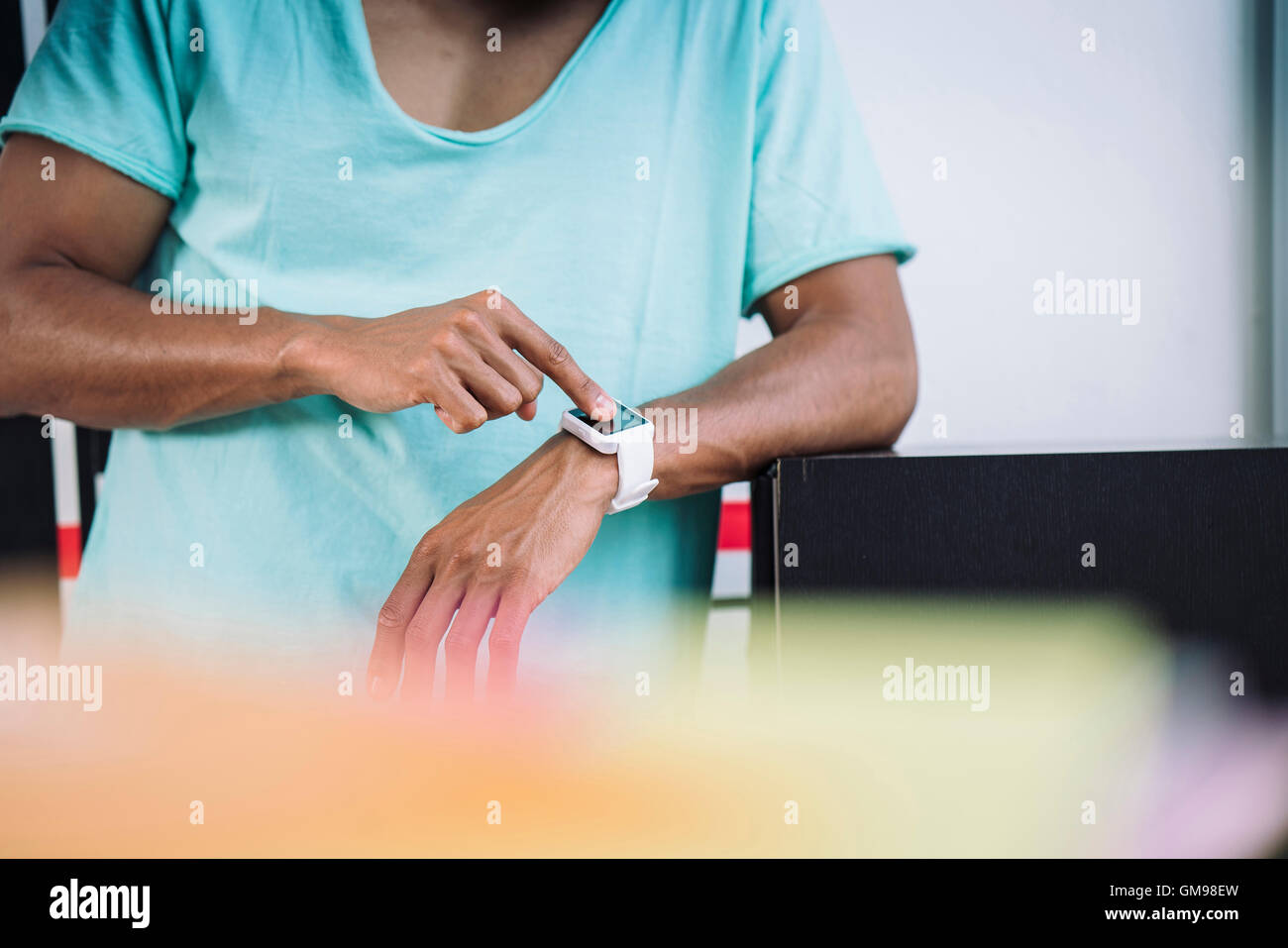 Young man using smartwatch Stock Photo - Alamy