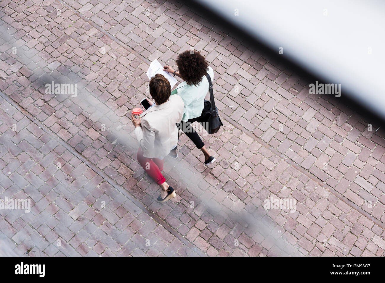 Two people walking together from above hi-res stock photography and ...