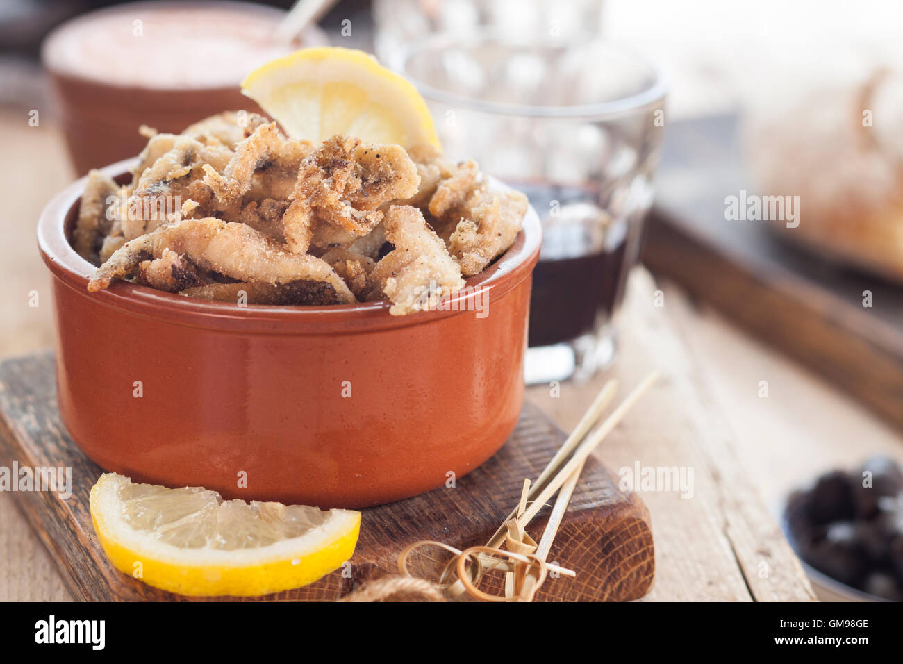 Tapas, boquerones fritos in bowl and slices of lemon Stock Photo - Alamy