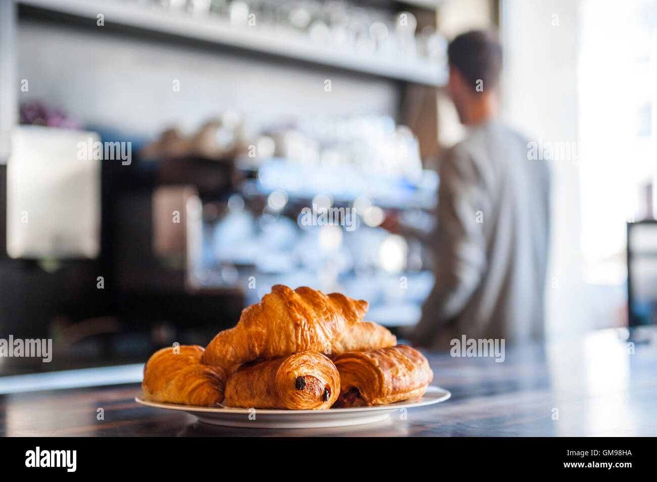Croissants on plate on counter of a cafe Stock Photo - Alamy