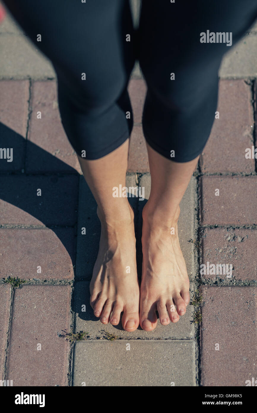Woman's feet on pavement Stock Photo - Alamy