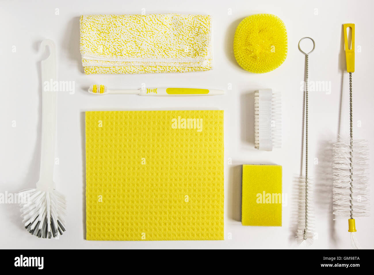 Yellow cleaning utensils on white background Stock Photo - Alamy