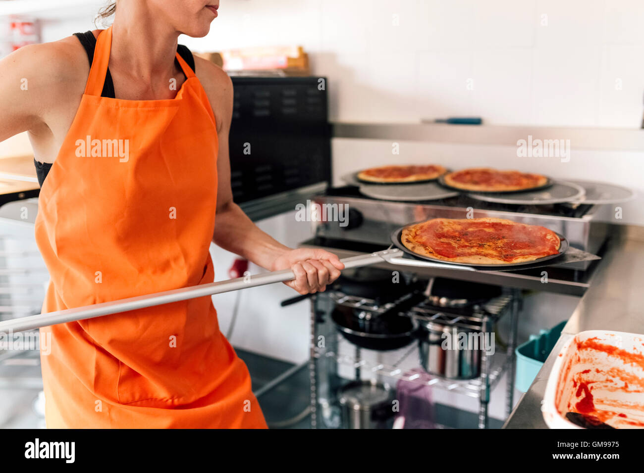 Pizza baker with ready pizza on peel Stock Photo - Alamy