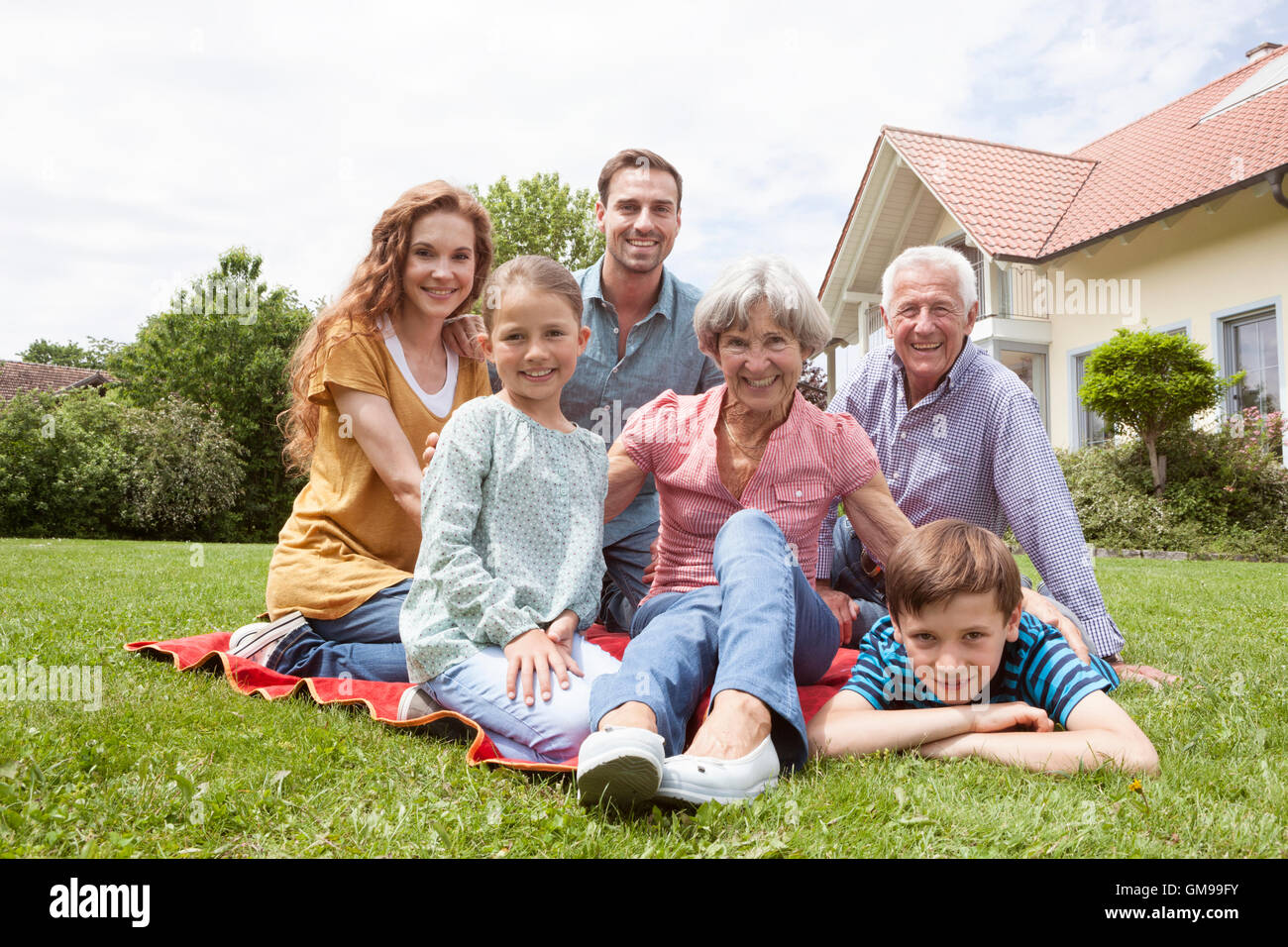 Portrait of happy extended family in garden Stock Photo - Alamy