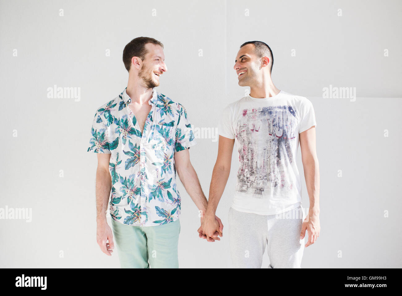 Two men in love holding hands Stock Photo - Alamy