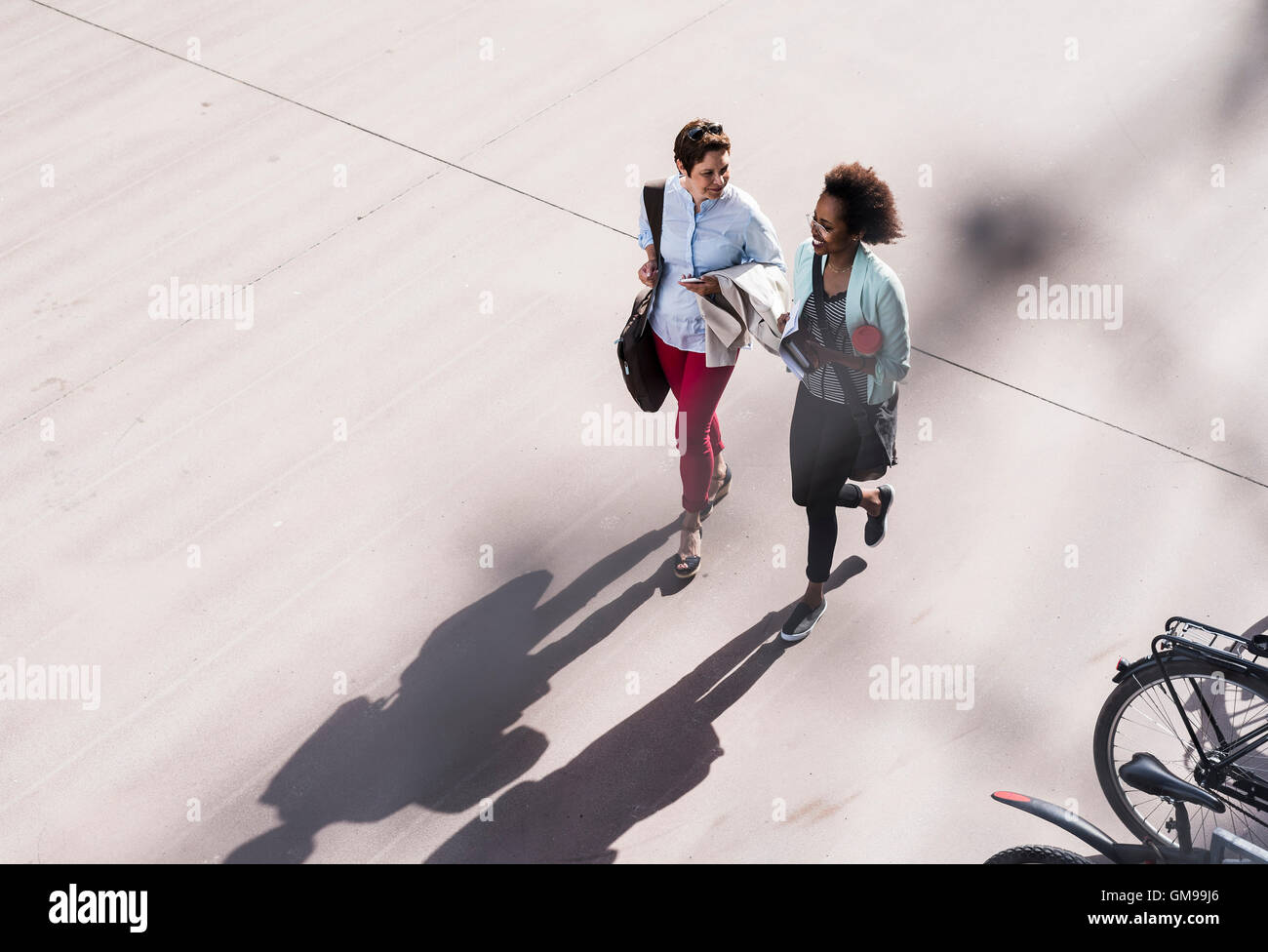 Two people walking together from above hi-res stock photography and ...