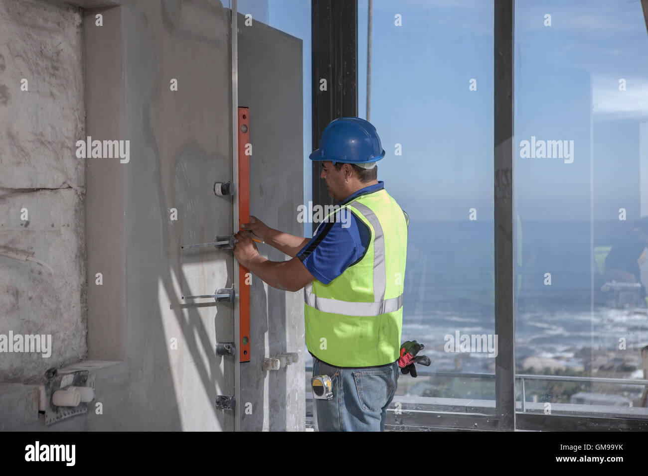 Construction worker using spirit level hi-res stock photography and ...