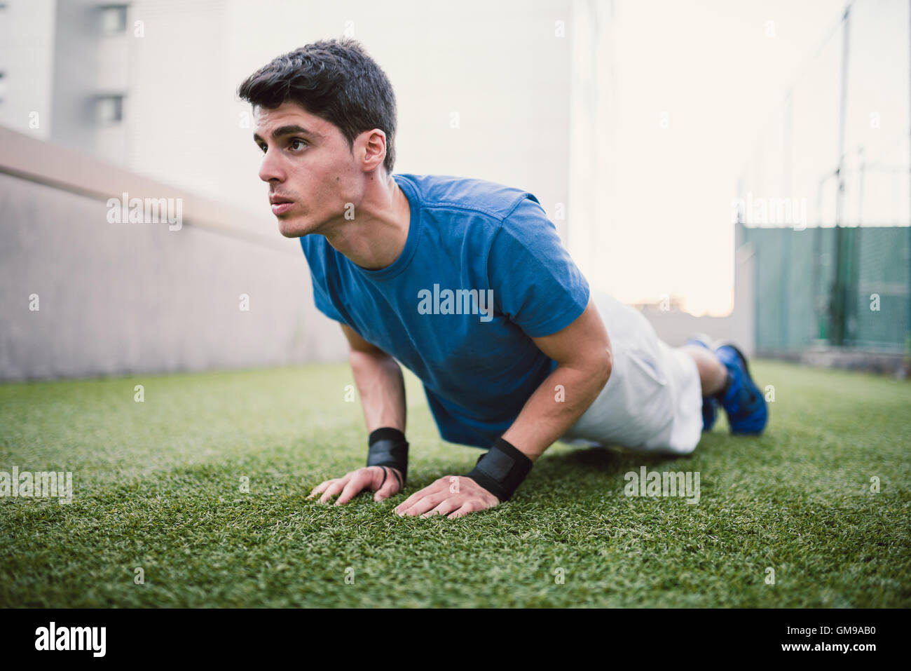 Athlete man doing pushups outdoor Stock Photo - Alamy