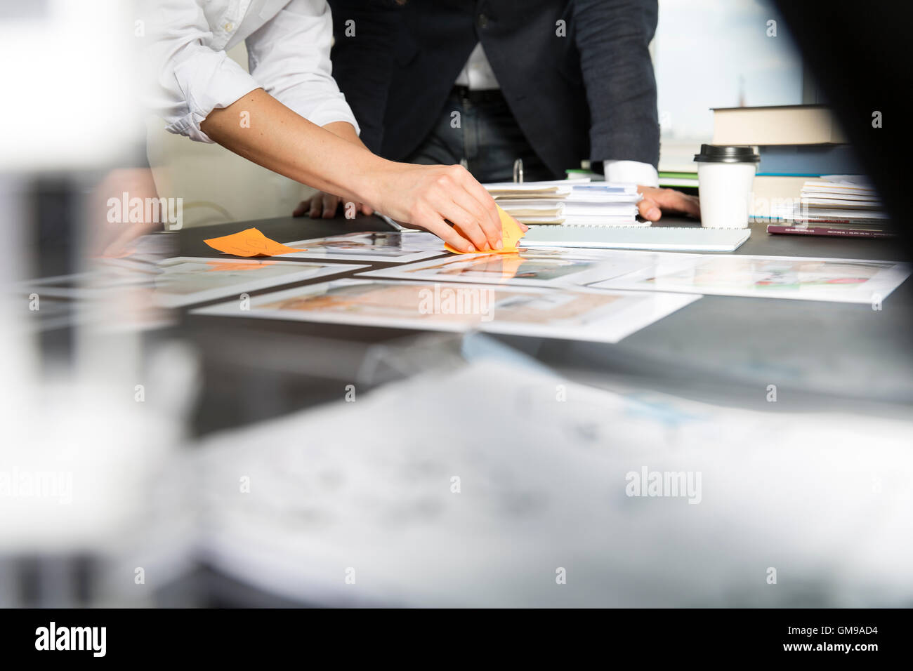 Hand of woman putting adhesive note on document Stock Photo - Alamy