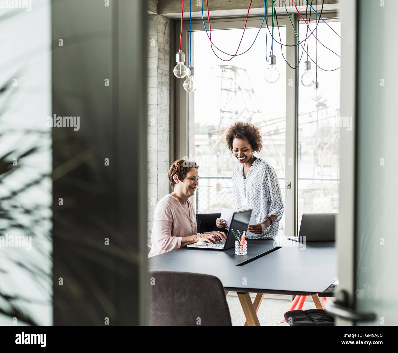 Two women working together in office Stock Photo - Alamy