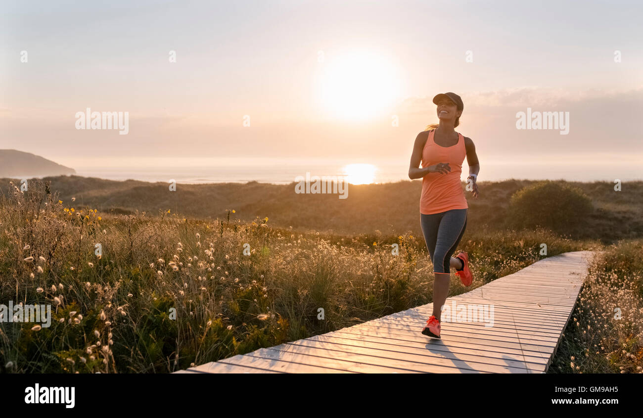Woman running along boardwalk hi-res stock photography and images - Alamy
