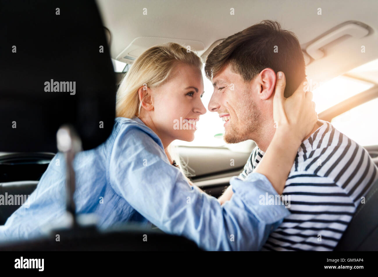 Smiling couple in love in a car Stock Photo - Alamy