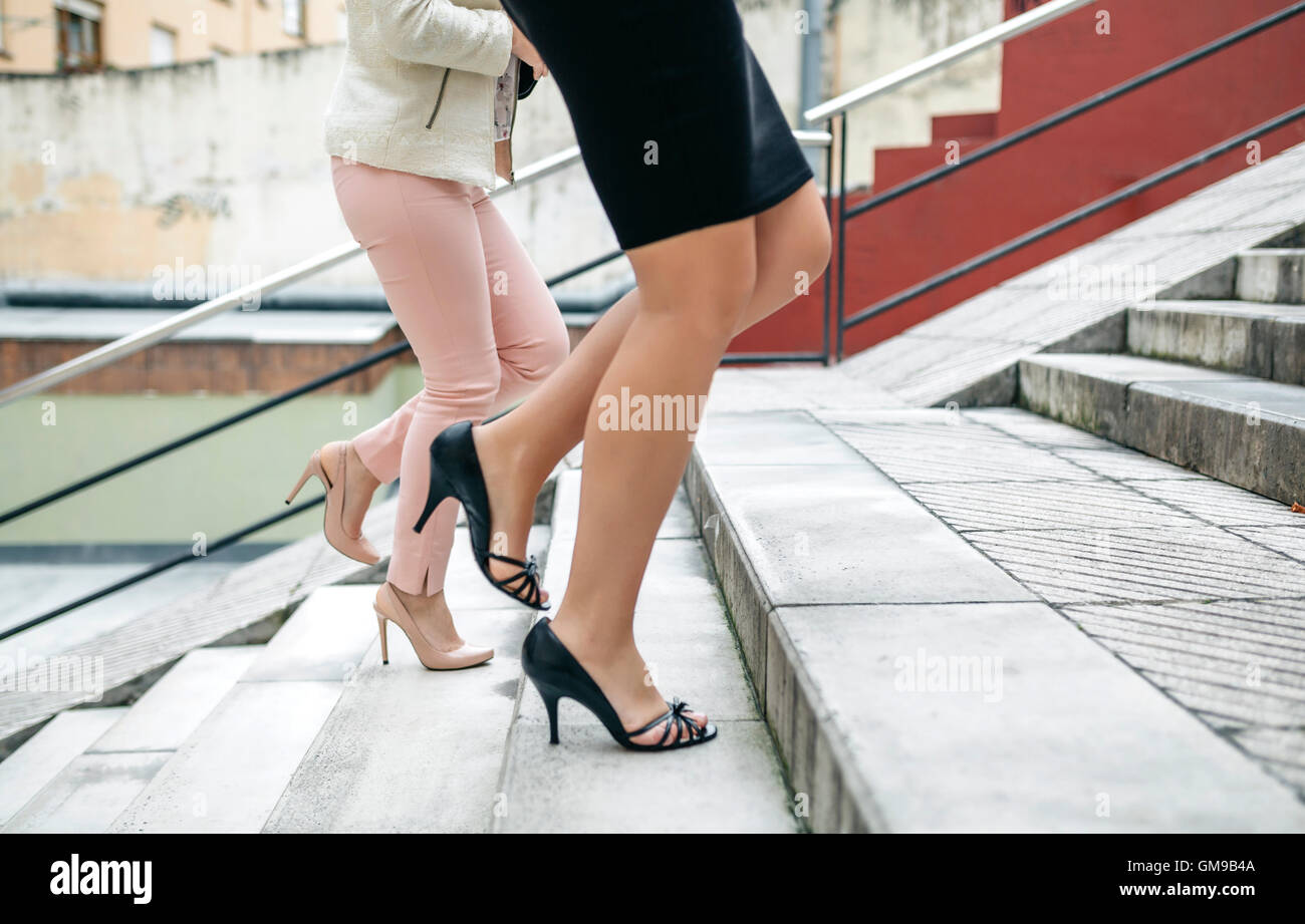 Two businesswomen walking upstairs Stock Photo - Alamy