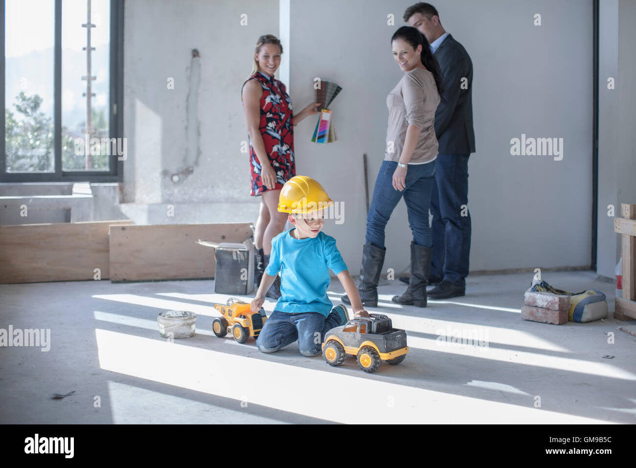 Boy with hard hat playing on construction site Stock Photo - Alamy