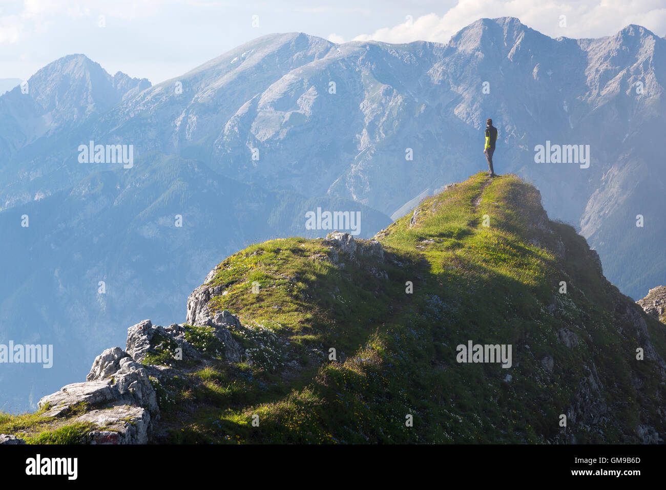 Austria, Tyrol, hiker standing on peak Stock Photo - Alamy