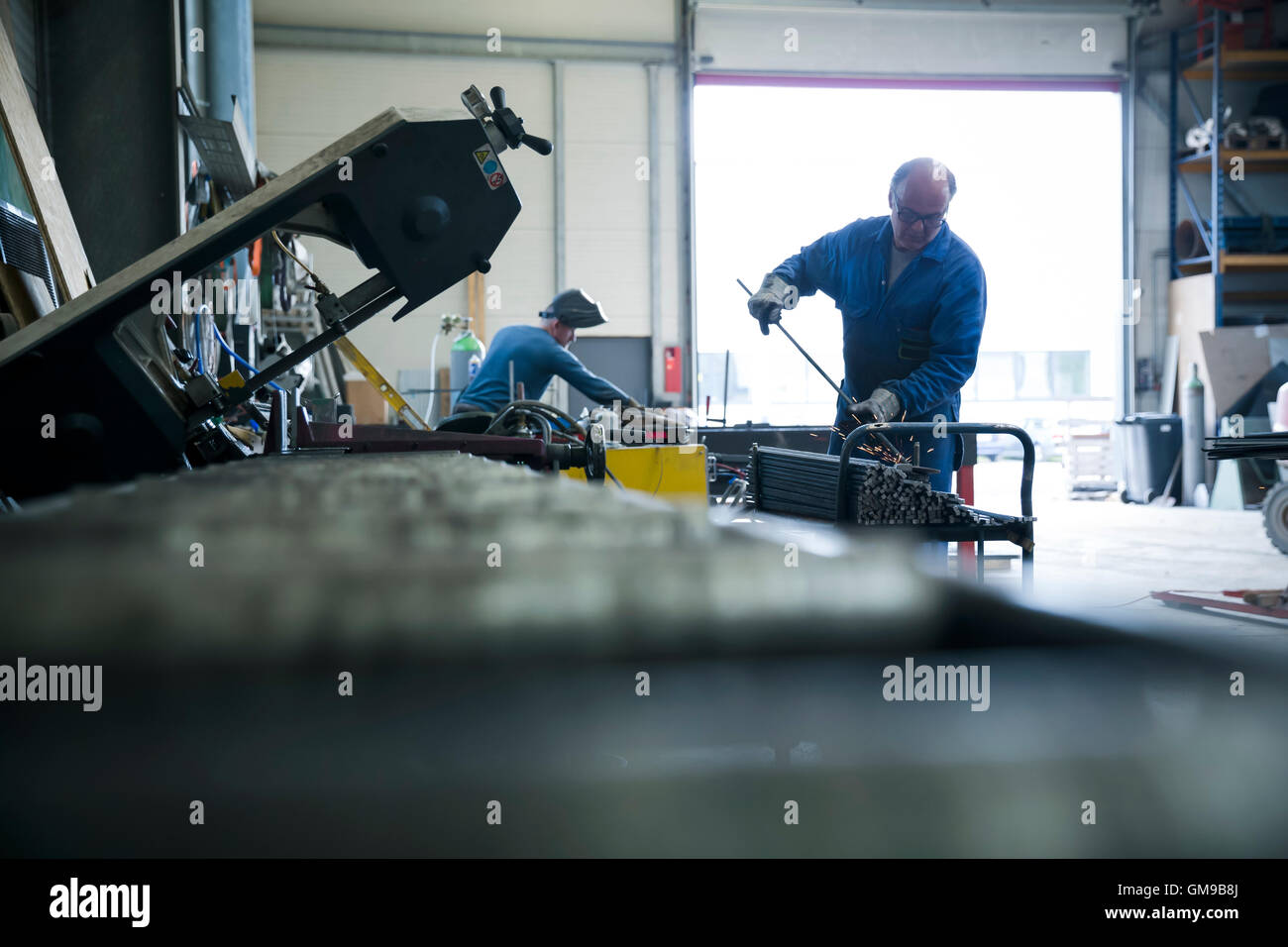 Metal construction, metal worker grading steel Stock Photo - Alamy