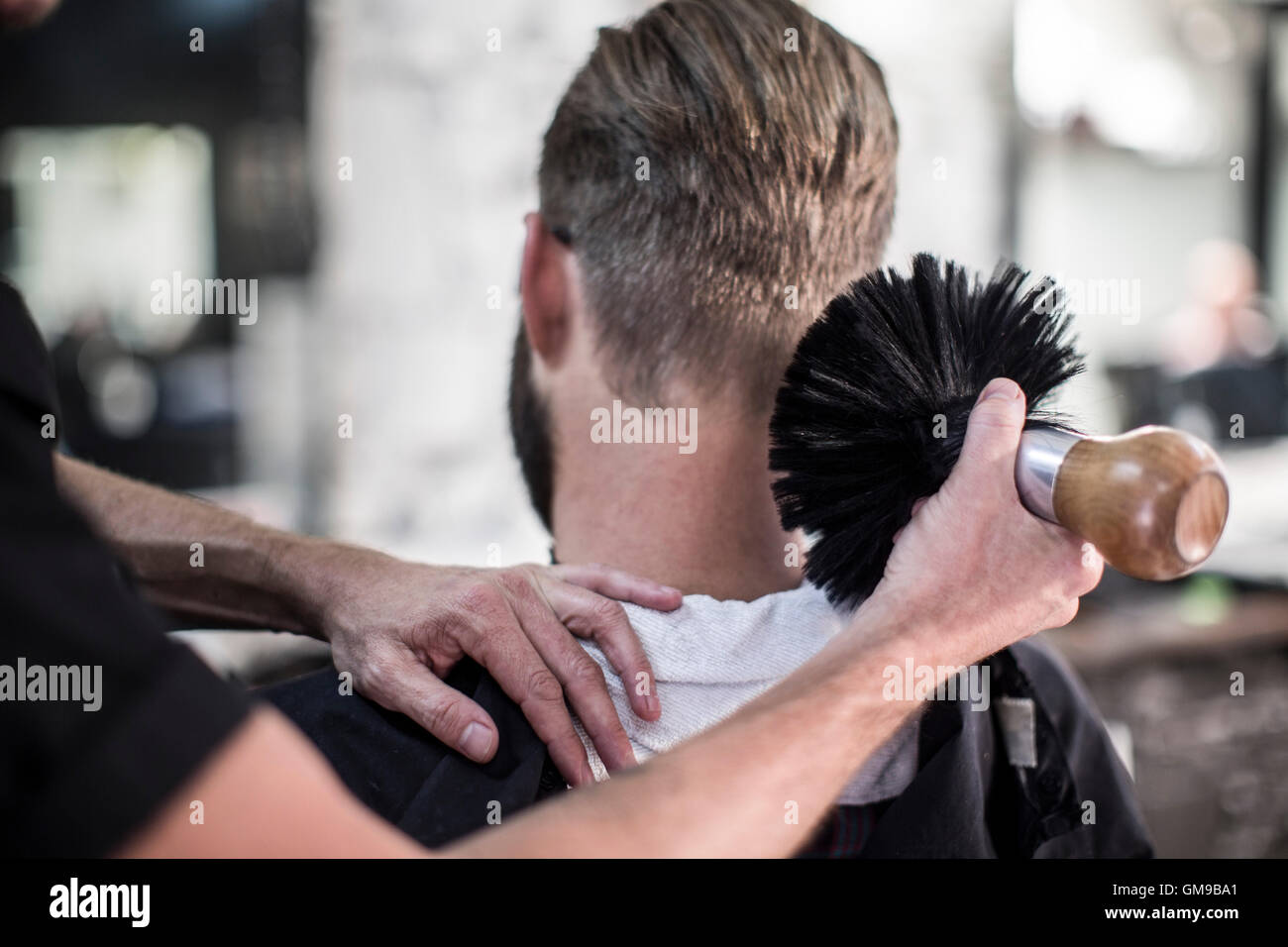 Barber brushing of customer Stock Photo - Alamy
