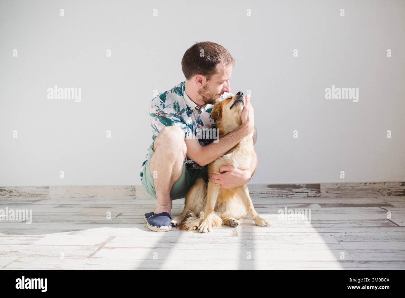 Man cuddling his dog Stock Photo - Alamy