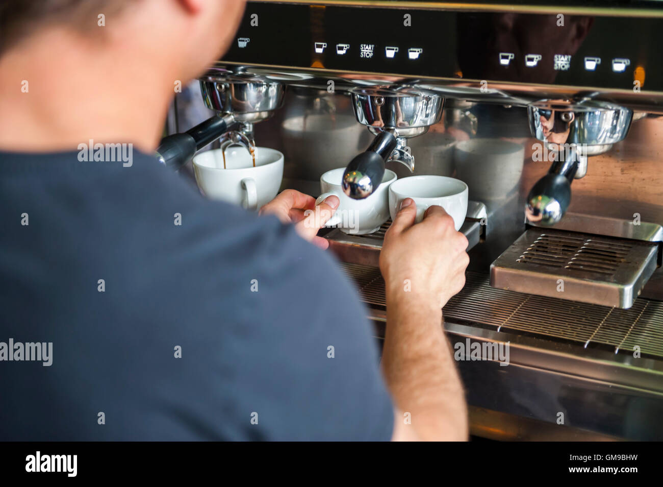 Man preparing coffee at coffee machine Stock Photo - Alamy
