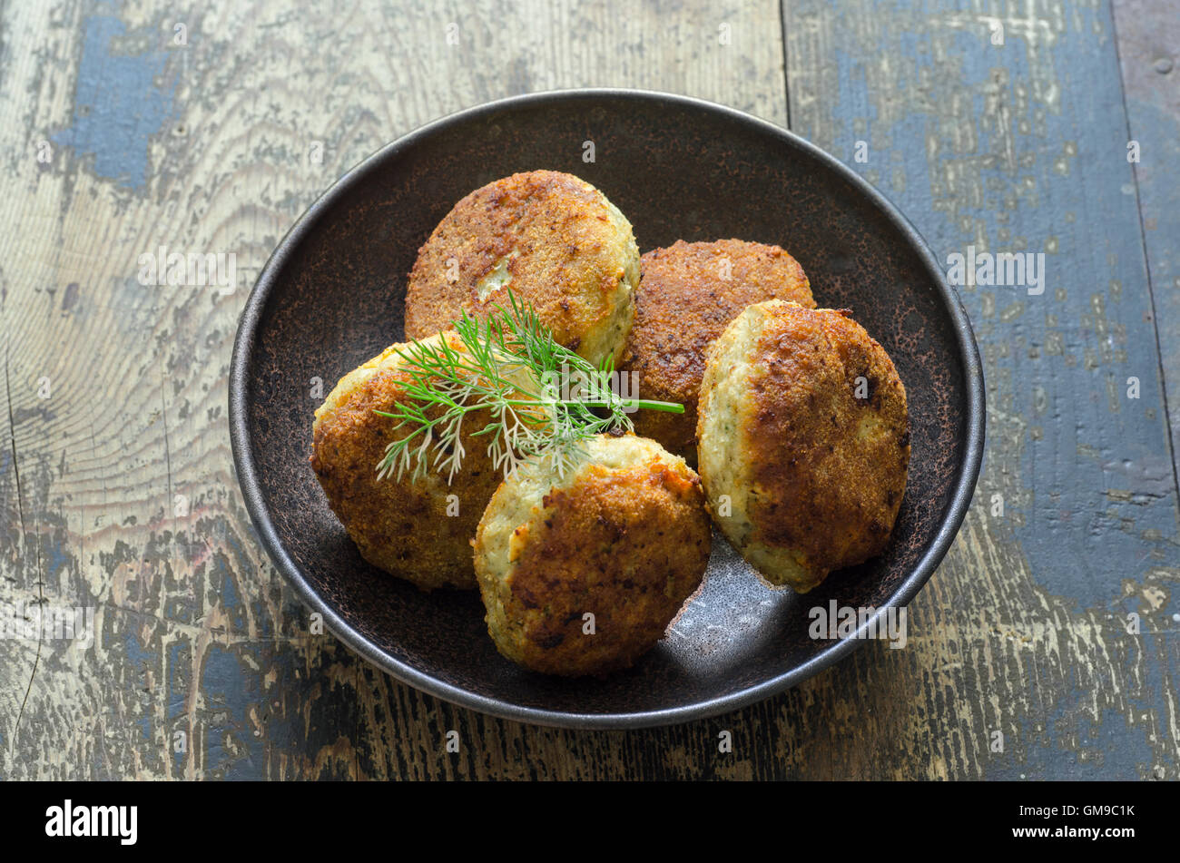 Homemade fish patties with dill in bowl Stock Photo - Alamy