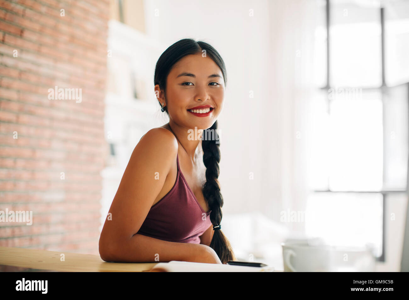Portrait of smiling woman at home Stock Photo - Alamy