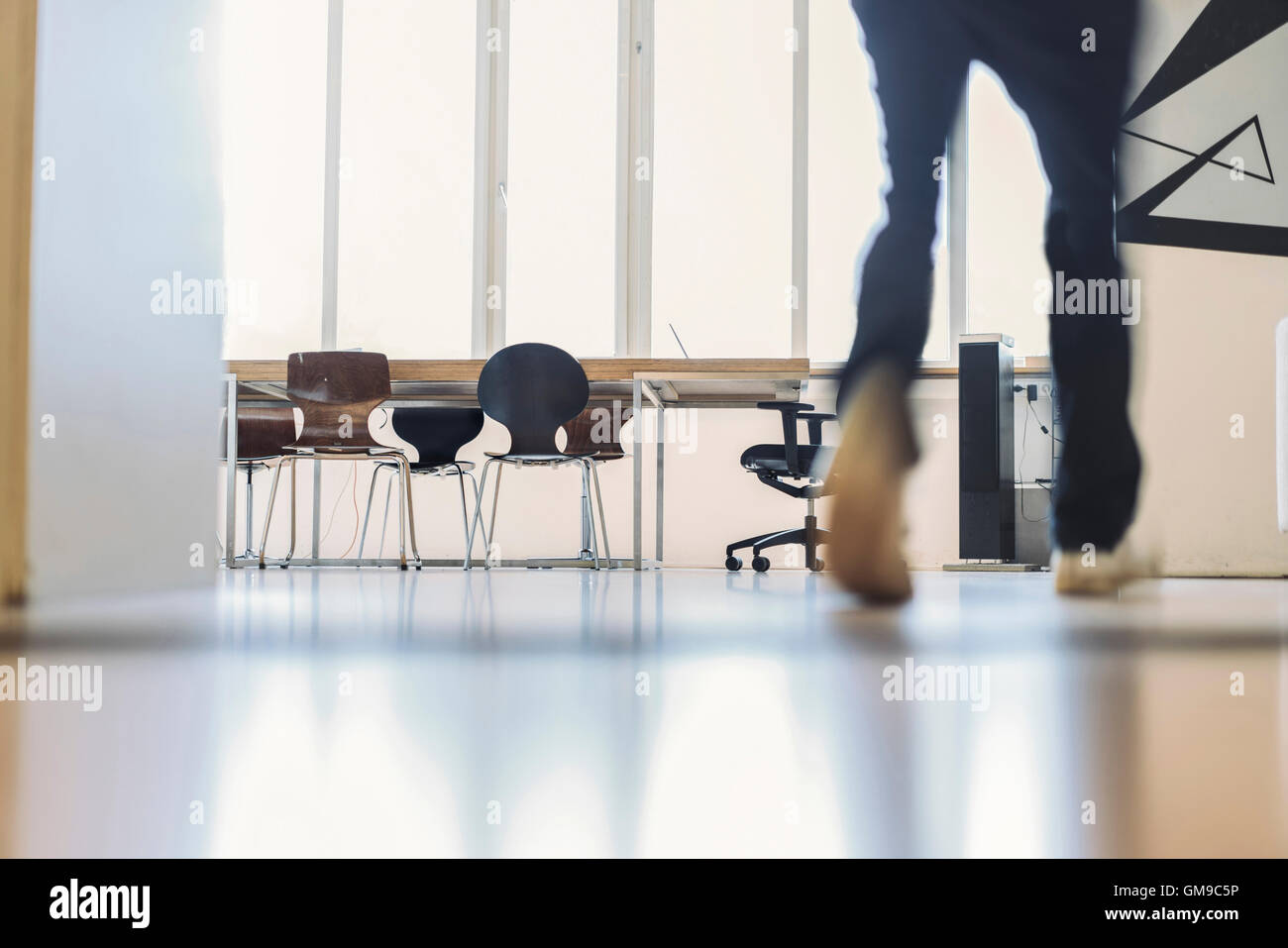 Legs of a man running in office Stock Photo - Alamy