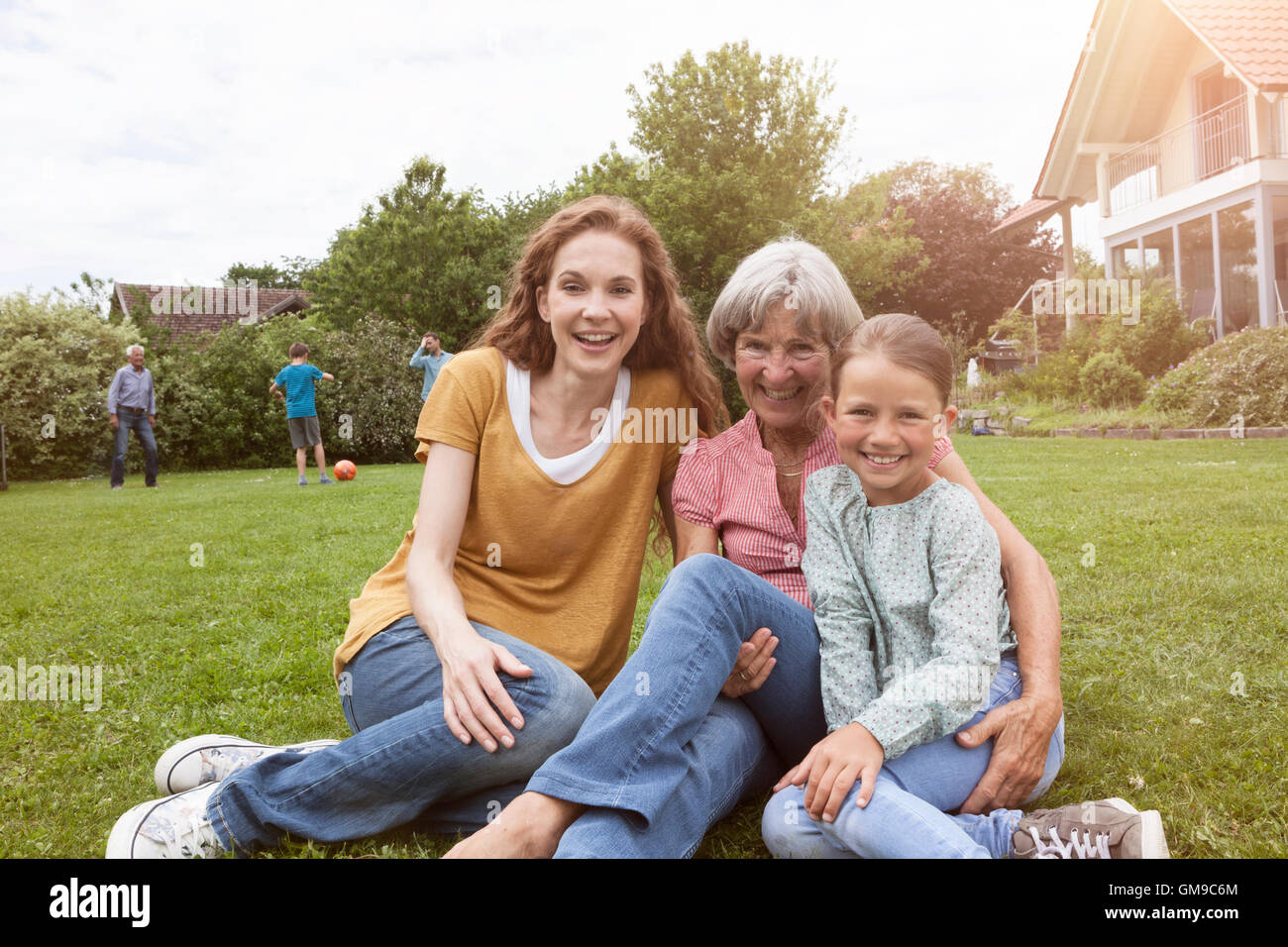 Portrait of happy extended family in garden Stock Photo - Alamy