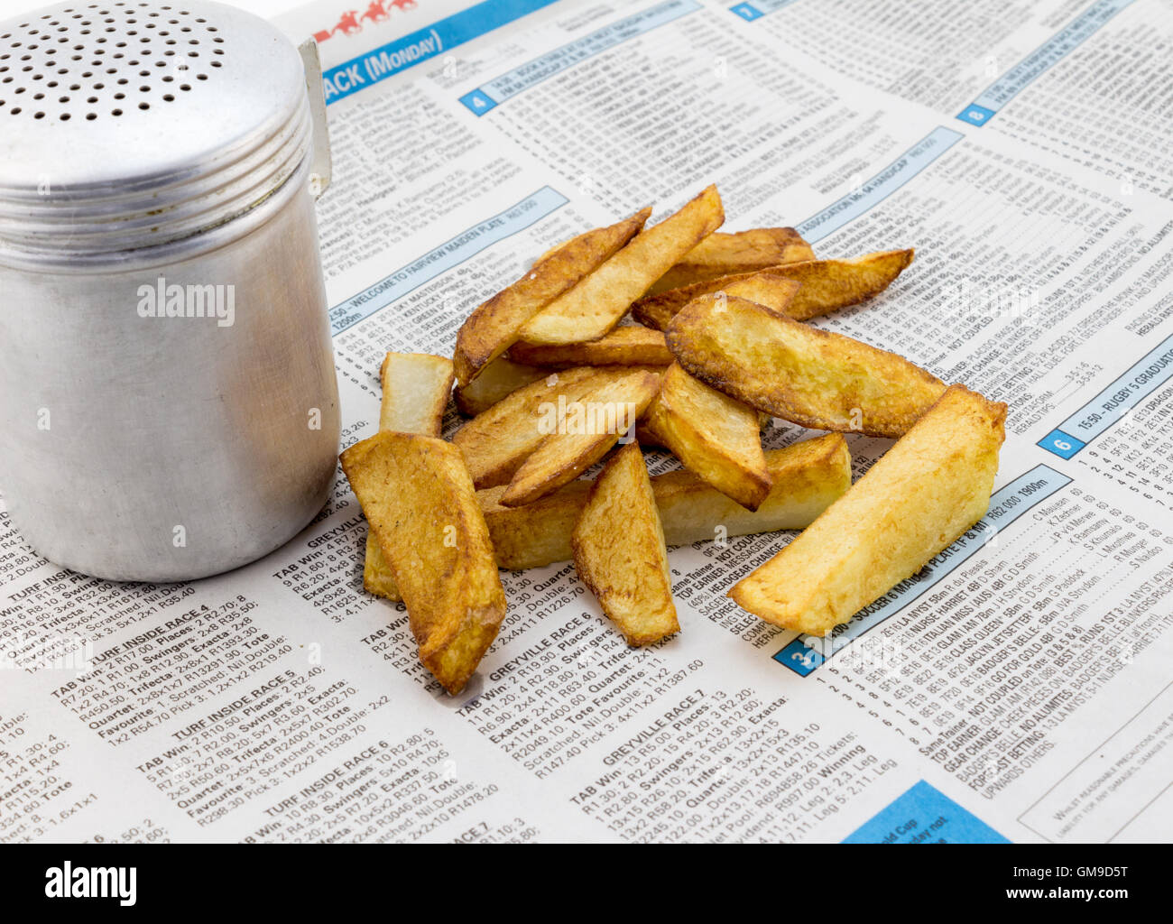 Small portion of french fries on news paper Stock Photo - Alamy