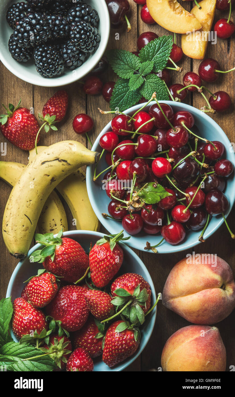 Summer fresh fruit and berry variety over wooden backdrop Stock Photo ...