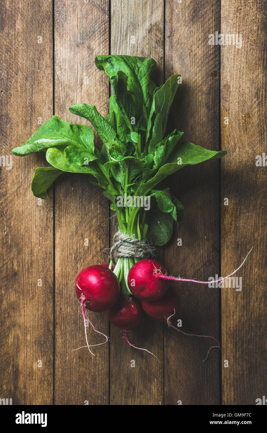 Fresh radish bunch over wooden background Stock Photo - Alamy